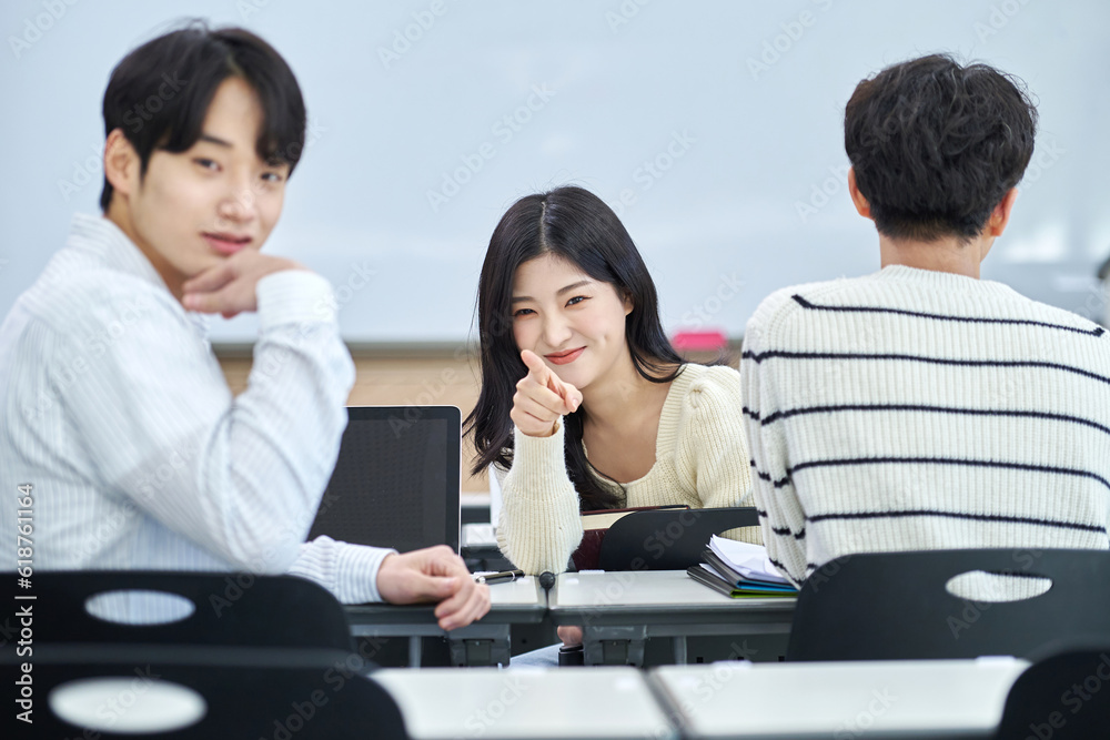 Male and female university students looking backwards talking or ...