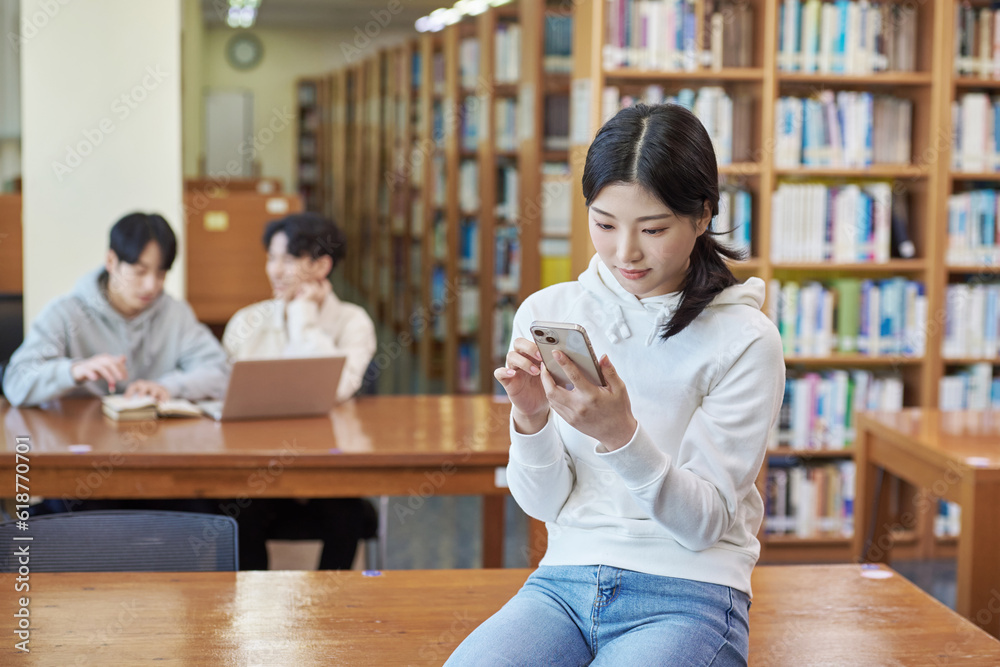 Young Asian Korean female model, male model and bookshelf background ...