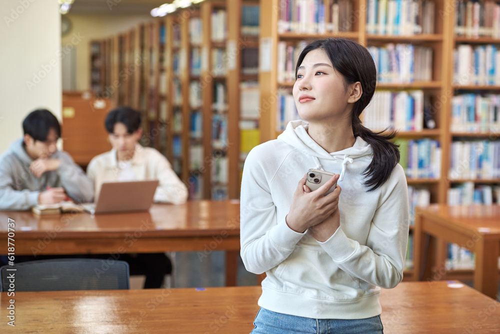 Young Asian Korean female model, male model and bookshelf background ...