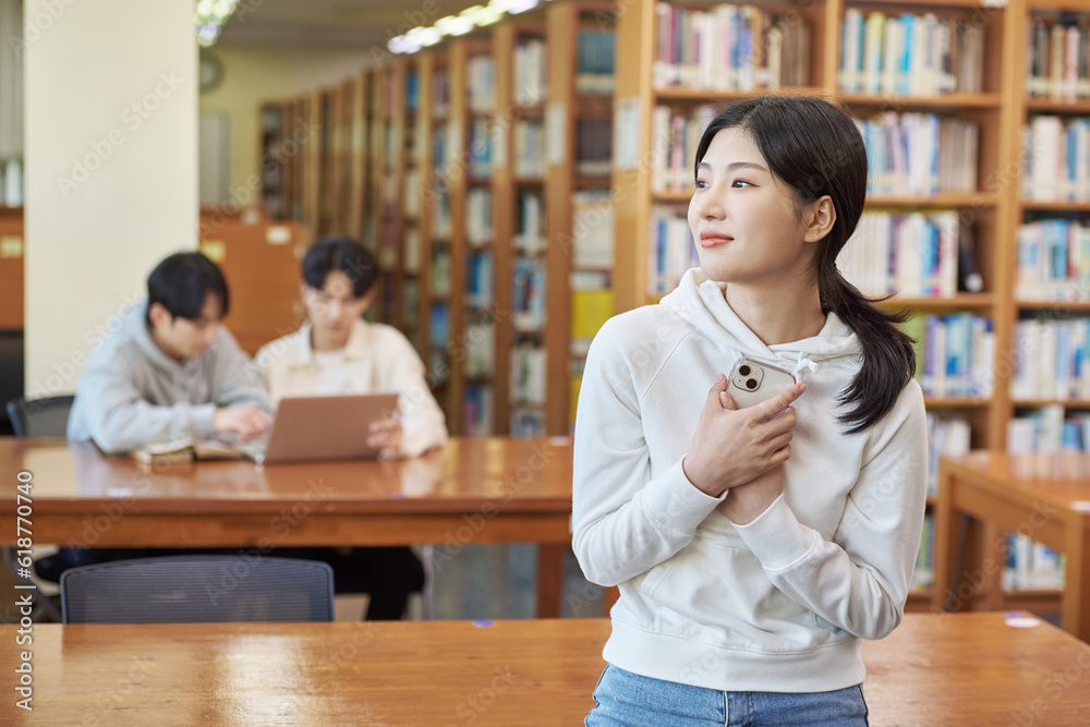Young Asian Korean female model, male model and bookshelf background ...