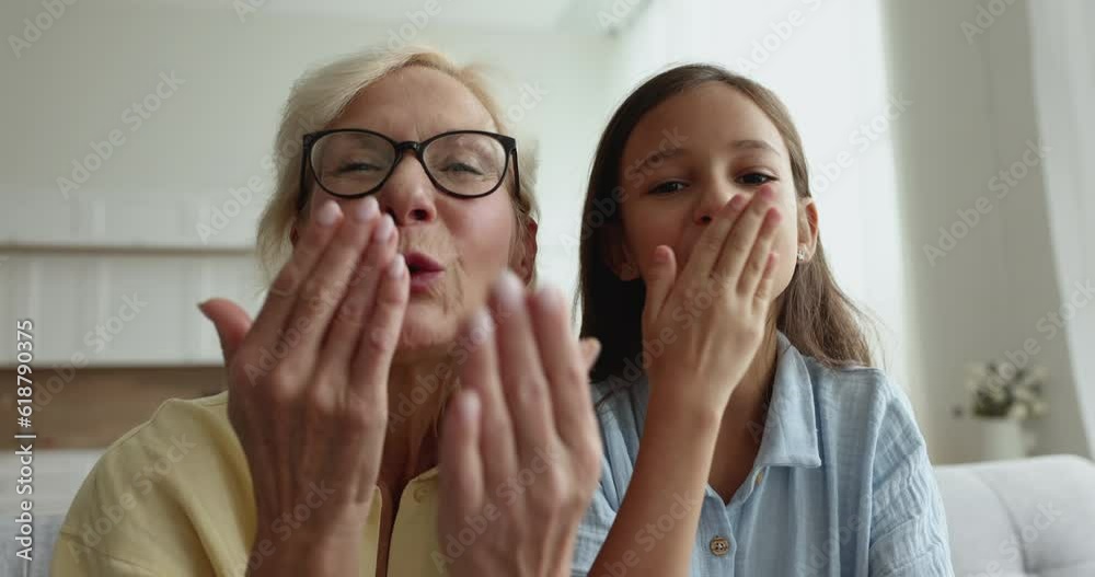 Close up granny and grandchild having fun calling via video call ...