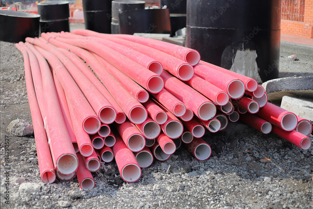 Red corrugated pipe for wire at construction site. Cable conduit for ...