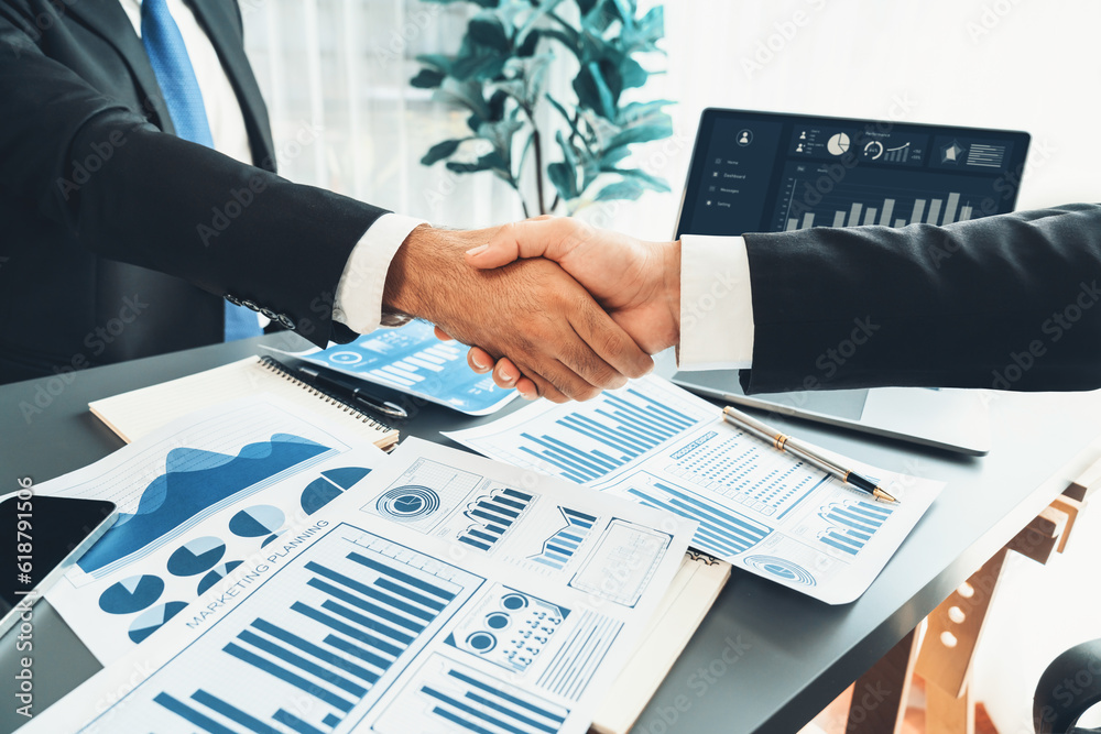 Closeup professional businessman shaking hands over desk in modern ...