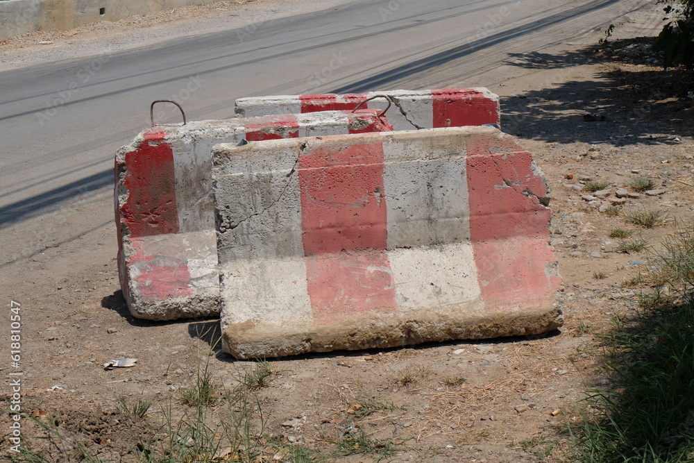 Concrete road blocks are placed to block the road path under ...