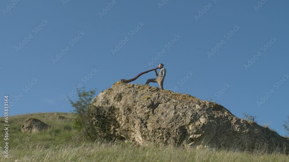 A musician plays the Australian Aboriginal musical instrument ...