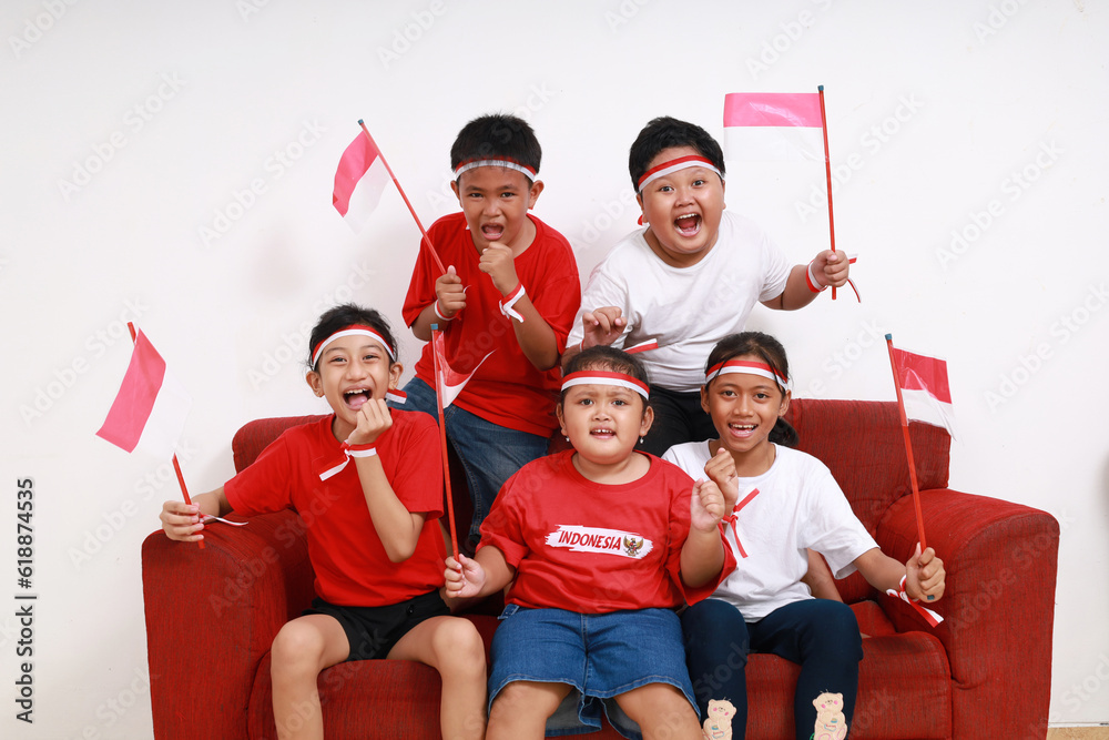Indonesian kids watching television to supporting Indonesian team Stock ...