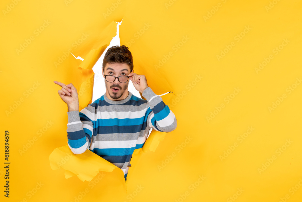front view young man taking off eyeglasses looking from the round ...