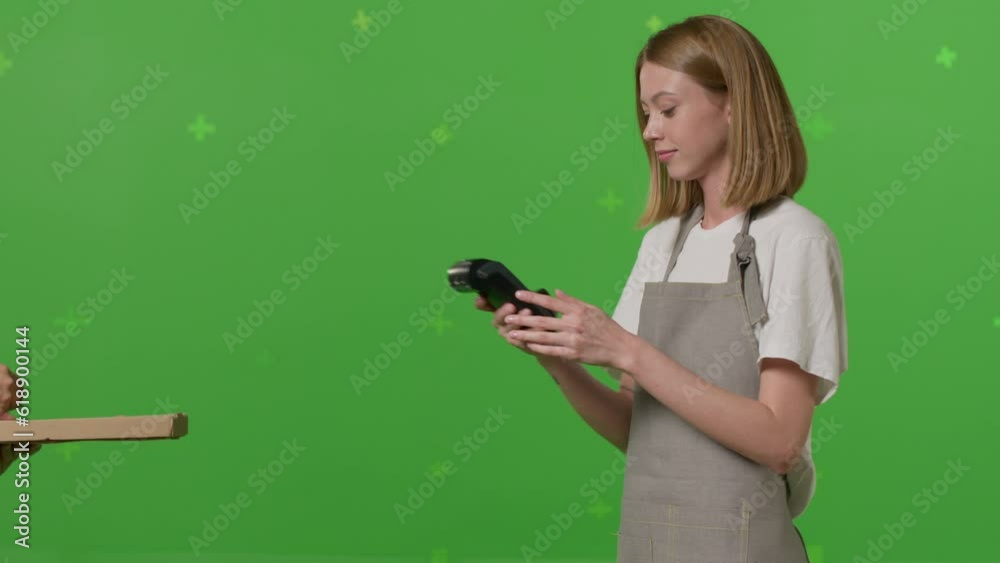 Girl waiter passing a box of pizza on green screen chroma key ...