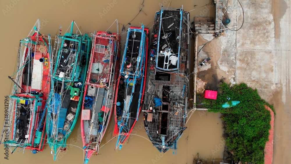 Fisherman village with traditional boat polluted water in harbor of ...
