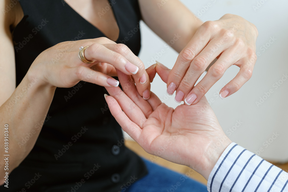 Certified Wingwave coach conducts a myostatic test with a client. Omura ...