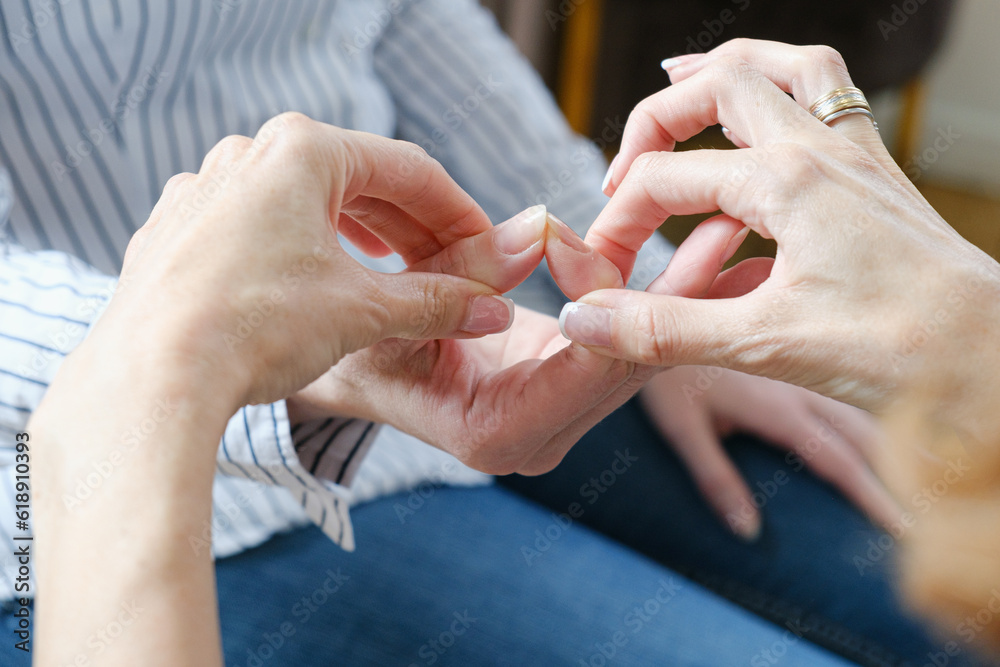 Certified Wingwave coach conducts a myostatic test with a client. Omura ...