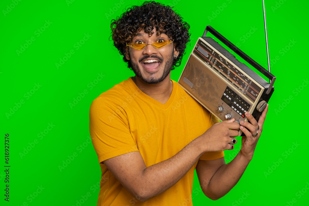 Indian man using retro tape record player to listen music, disco ...