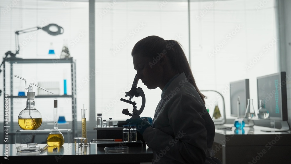 Medical scientific laboratory. Side view of a dark silhouette of a ...