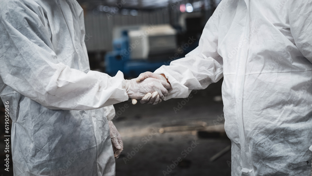 Scientist workers wear protective suit shack hand with team when ...