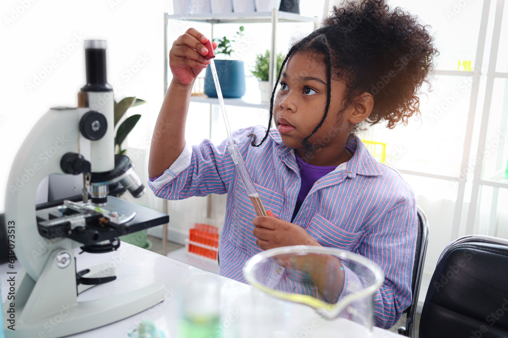 Primary school African curly hair girl does chemistry science ...