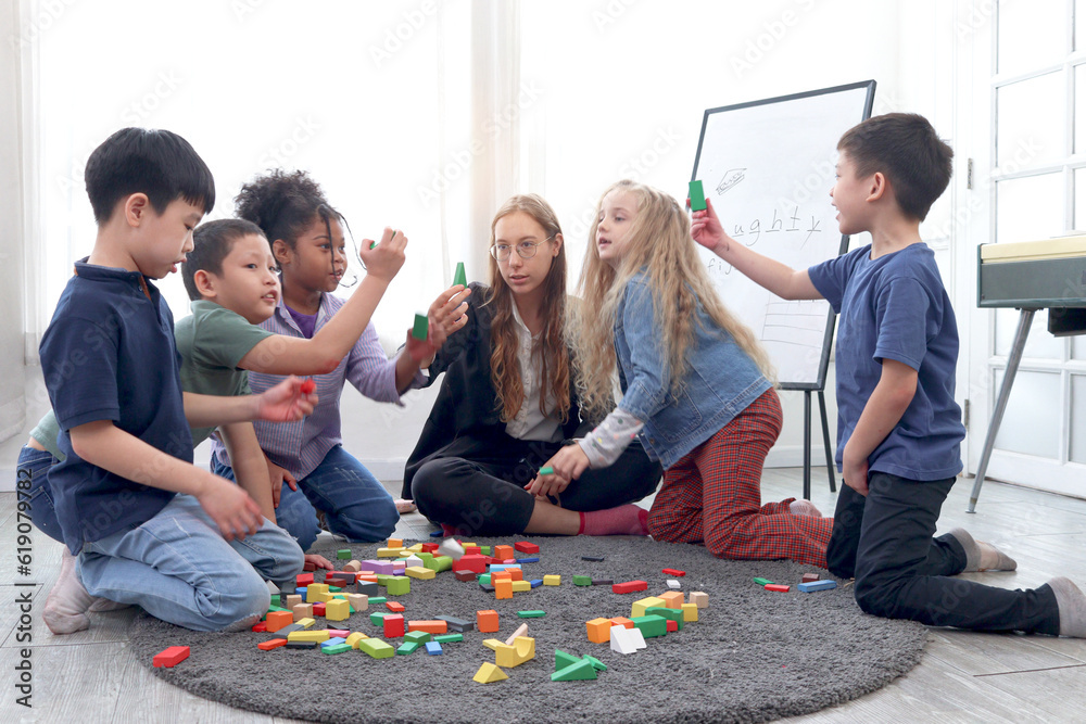 Group of primary school children study and play together in classroom ...