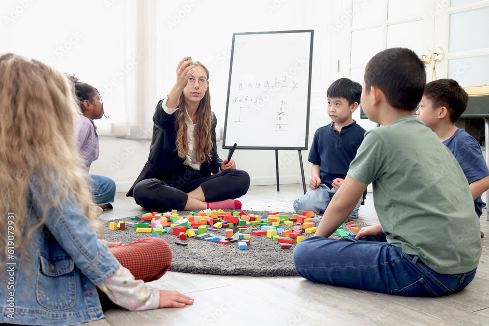 Group of primary school children study and play together in classroom ...