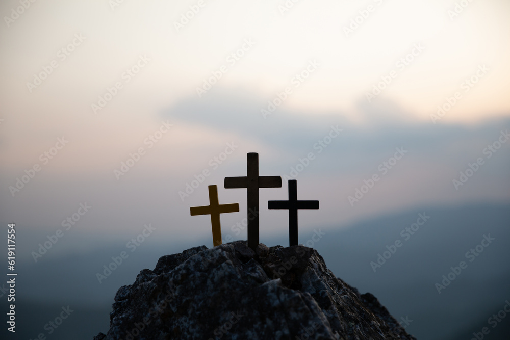The three holy crosses of Jesus Christ shining through the red sky and ...