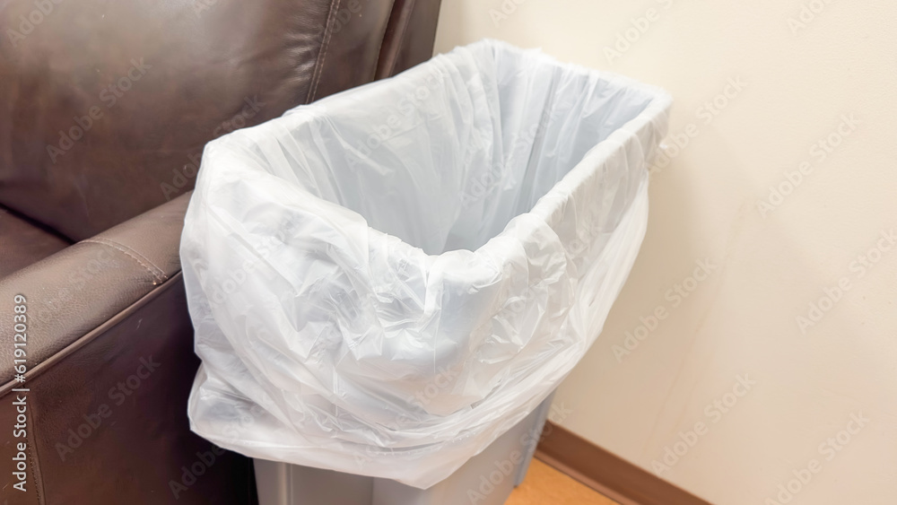 plastic-filled trashcan, symbolizing the detrimental impact of plastic ...