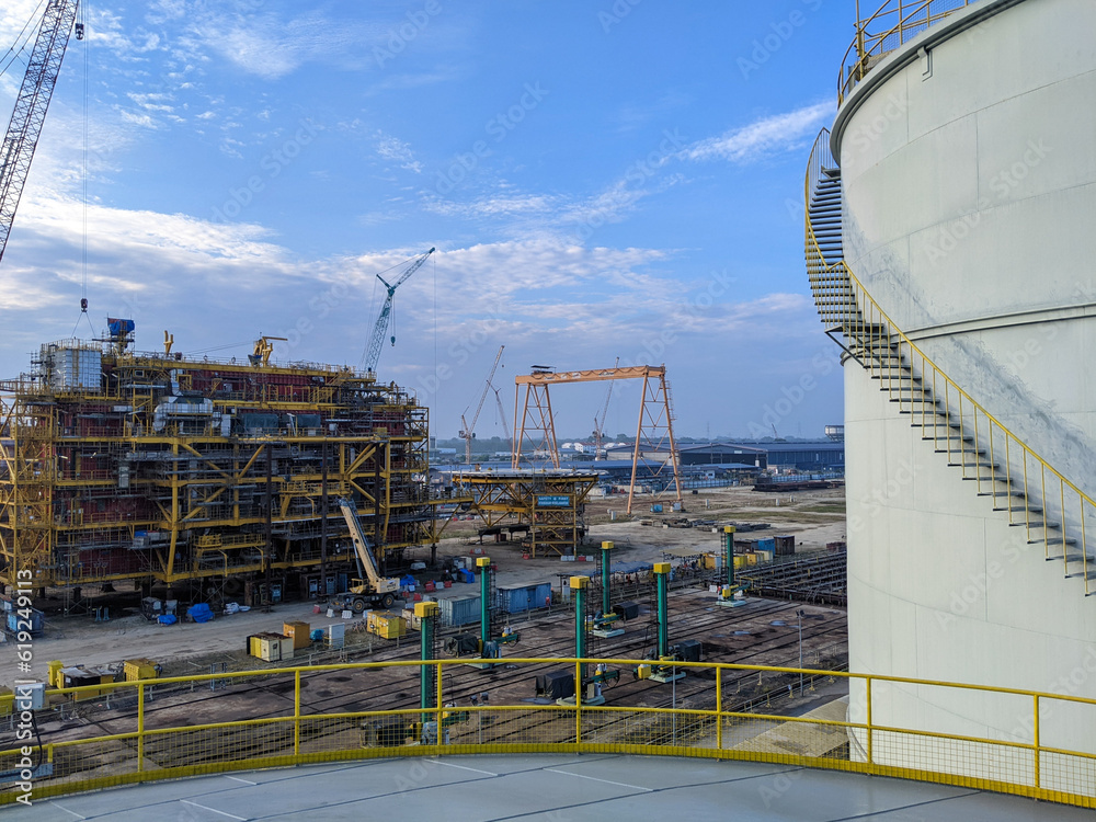 Oil storage tanks in an industrial area with the background of the oil ...
