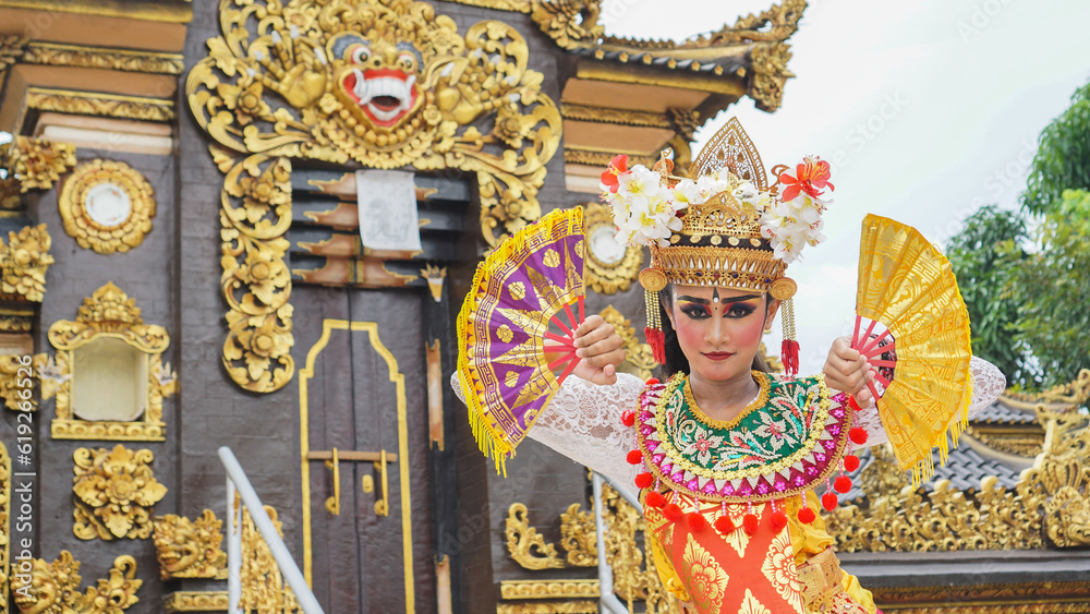 girl wearing Balinese traditional dress with a dancing gesture on ...