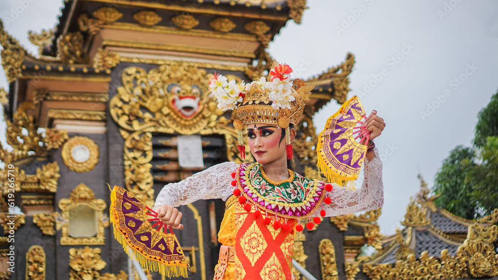girl wearing Balinese traditional dress with a dancing gesture on ...