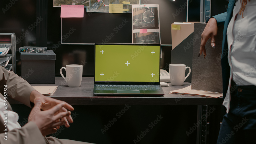 Man and woman working with greenscreen on pc, sitting in evidence room ...
