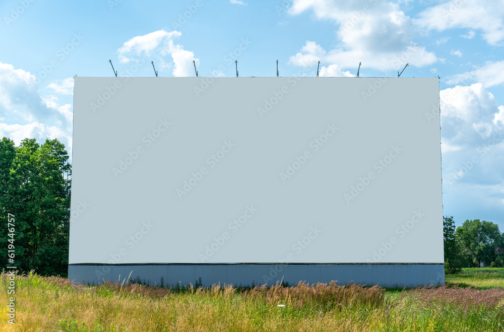 Blank billboard mockup for outdoor advertising standing in green meadow ...