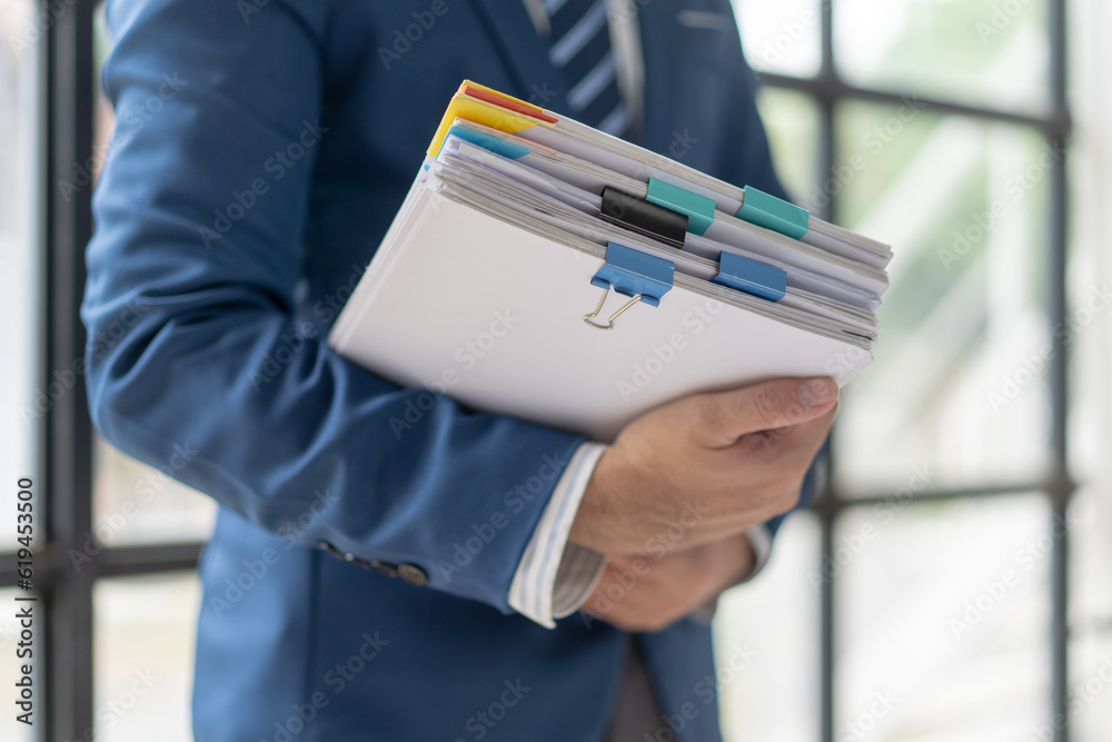Businessman Preparing reports papers with graphs, charts on Stacks of ...
