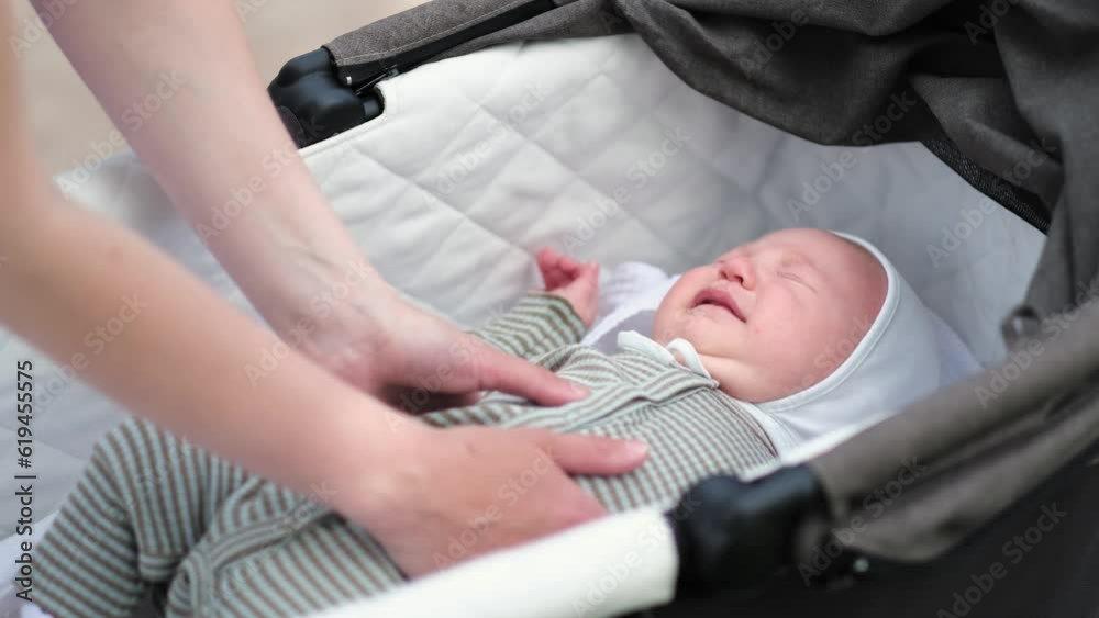 Mom tries to calm her crying baby, hugging and soothing her crying son ...