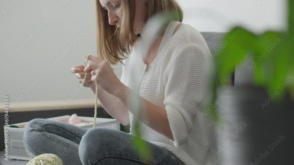 A woman knits elegant amigurumi, weaving yarn into homogeneous loops ...