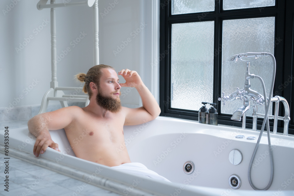 Handsome young man relaxing in bathtub at home. Man in bathtub Stock ...