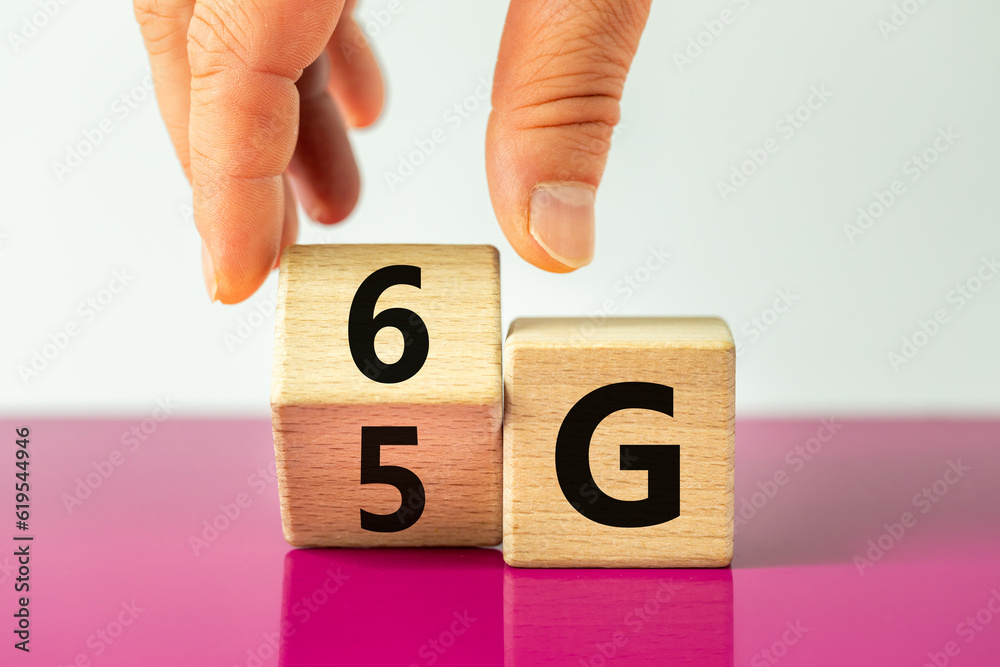 time for the 6G symbol. The hand rotates the wooden cube and changes ...