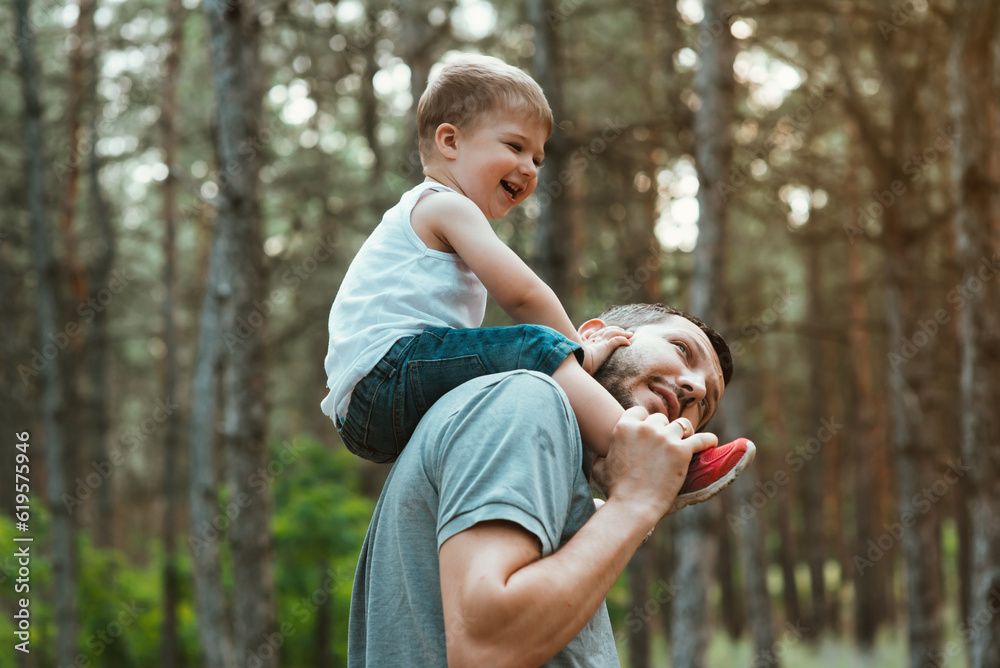 father's day. Happy European-looking father walks with his young cute ...