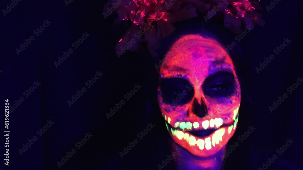 Woman make up as a Katrina uses neon paint to simulate skeleton and ...