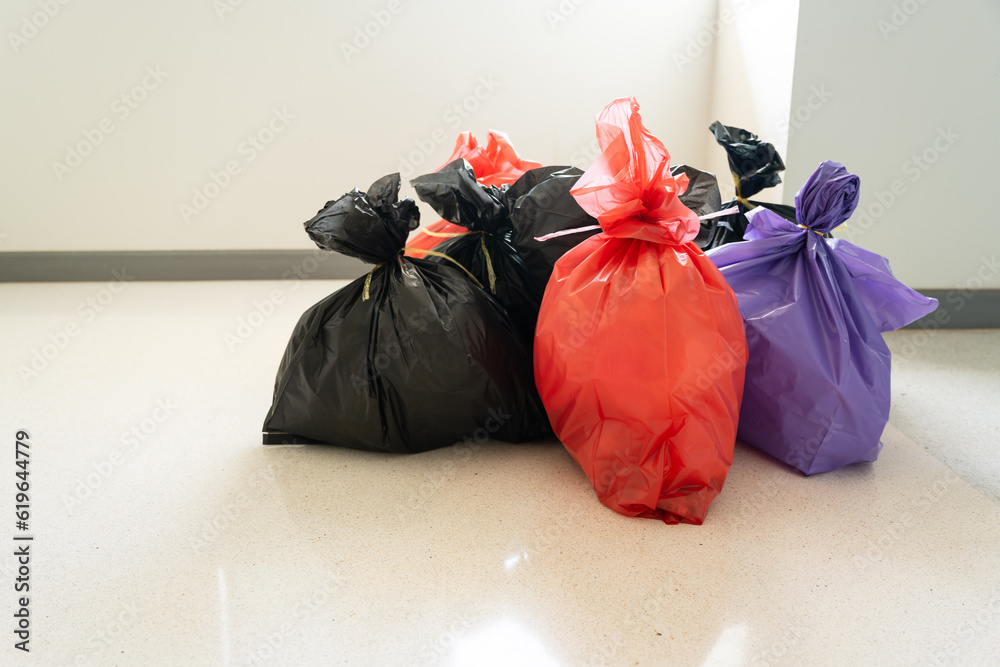 Different waste bag on white floor background,Red, black and purple ...