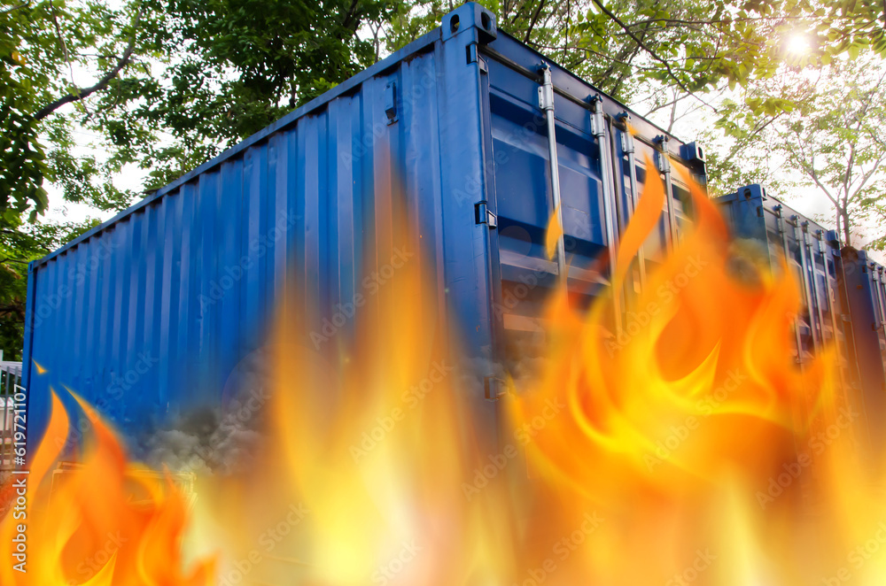 Cargo container with fire in front of blue sky background. Logistics ...