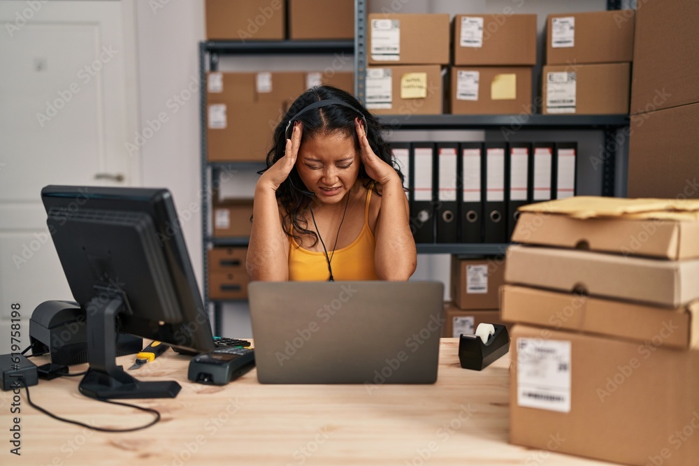 Young asian woman working at small business ecommerce wearing headset ...