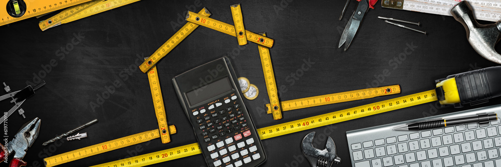 Folding wooden ruler in the shape of a house on a workbench with work ...