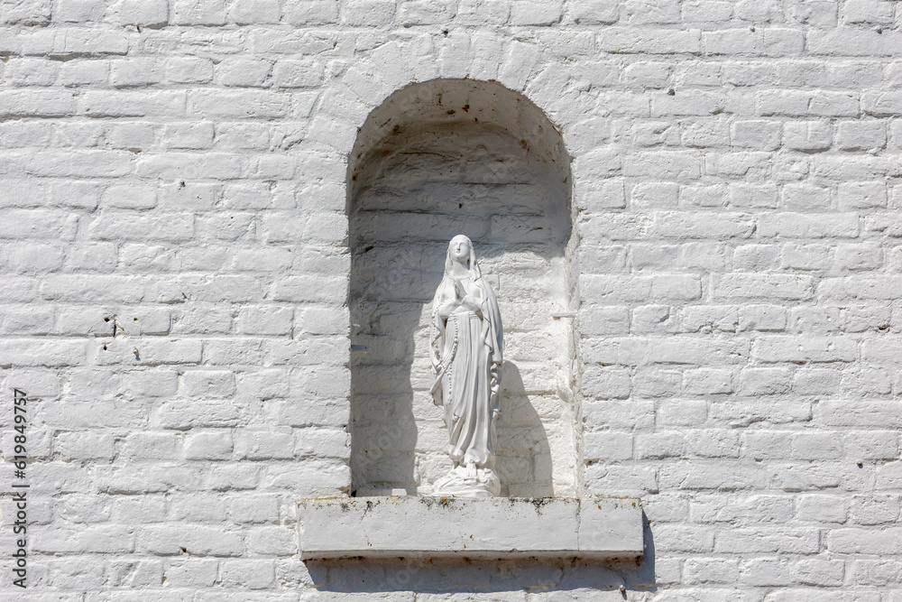 Saint Mary statue in the white bricks wall, A first-century Jewish ...