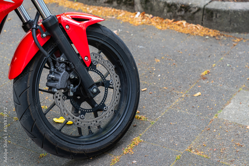 Front wheel of a red motorcycle with disc brakes. Close up. Stock Photo ...