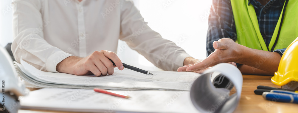 architect explaining client demand plan of construction on the table to ...