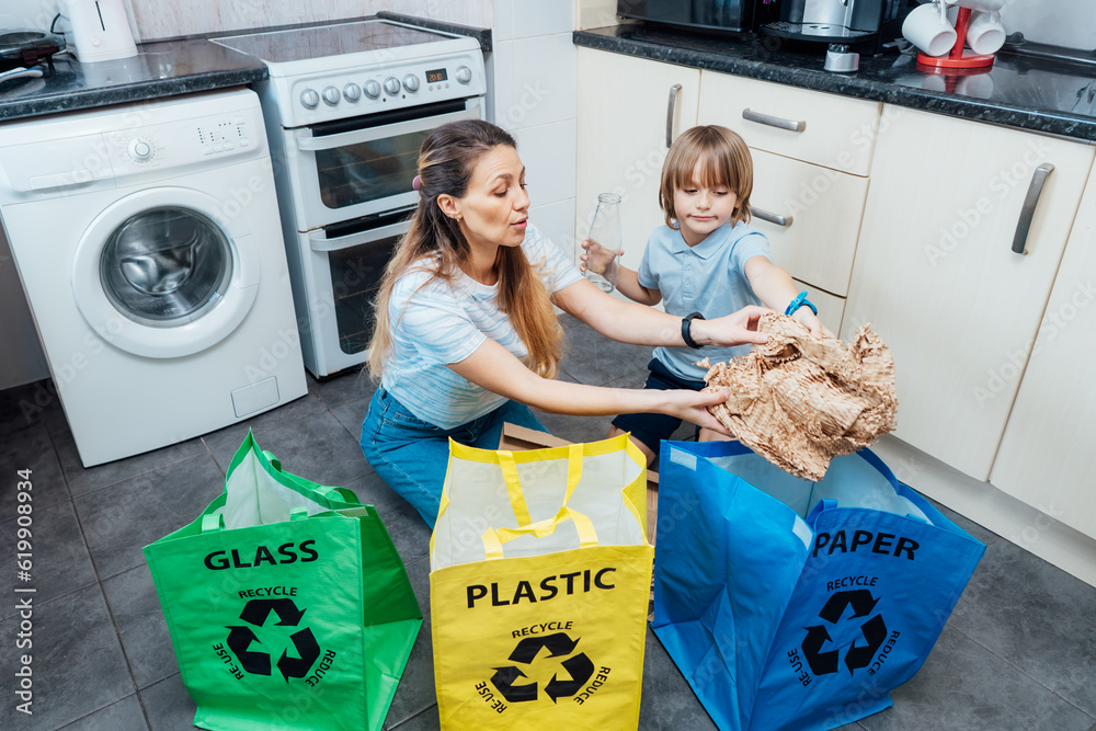 Mother is teaching kid how to recycle help the boy aware environmental ...