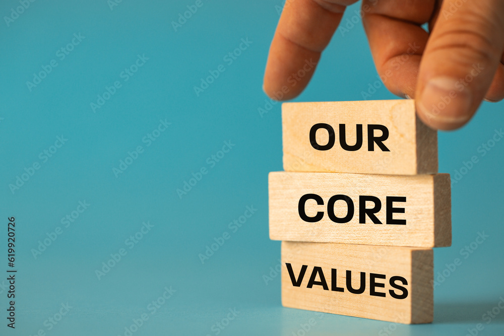 our company core values, Concept, Hand arranging wooden blocks with ...