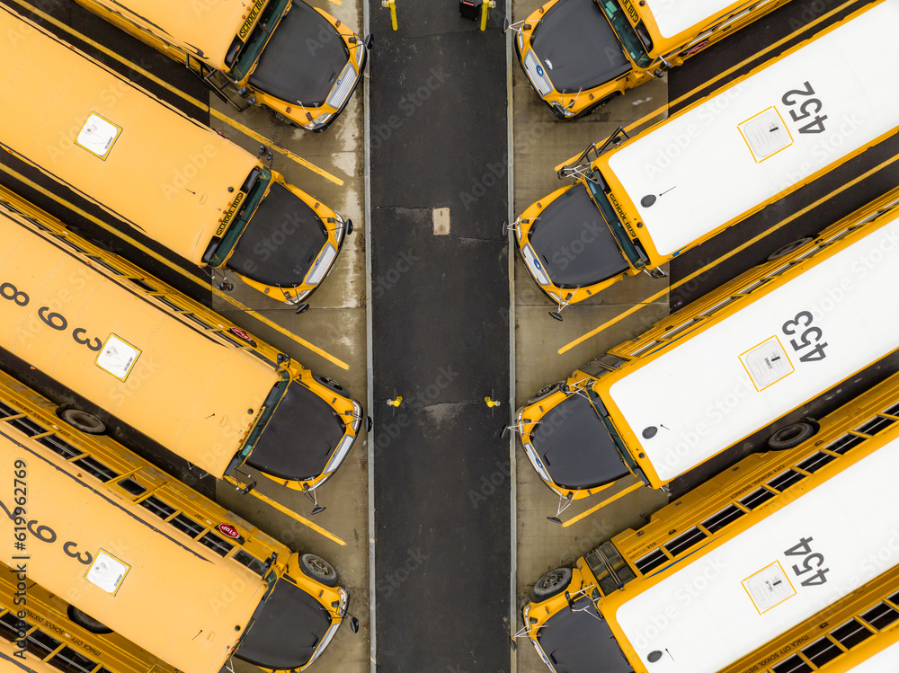 Aerial view of yellow school buses in a concrete parking lot. Stock ...