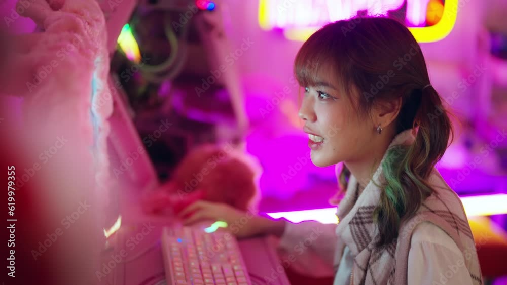 Young Asian woman esport player playing online game on computer in ...