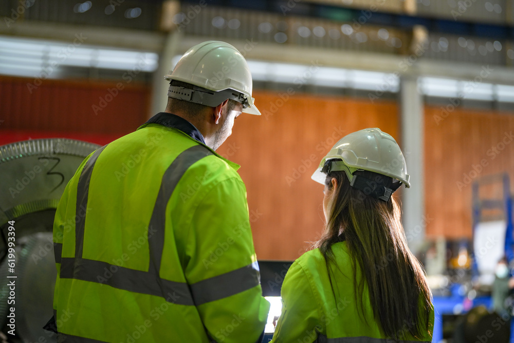 Professional engineering workers walk and check in warehouse factory ...
