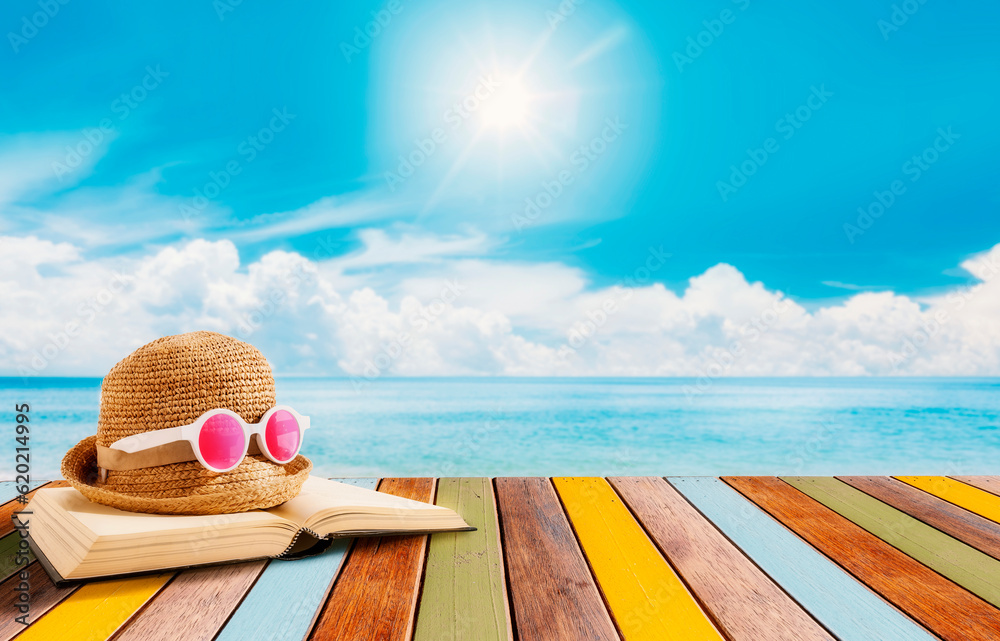 Open book on multicolor wood panel and sea beach background. Summer ...