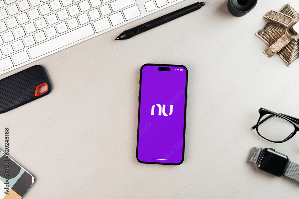 Nubank app on the smartphone iPhone 14 Pro screen on gray table. Top ...