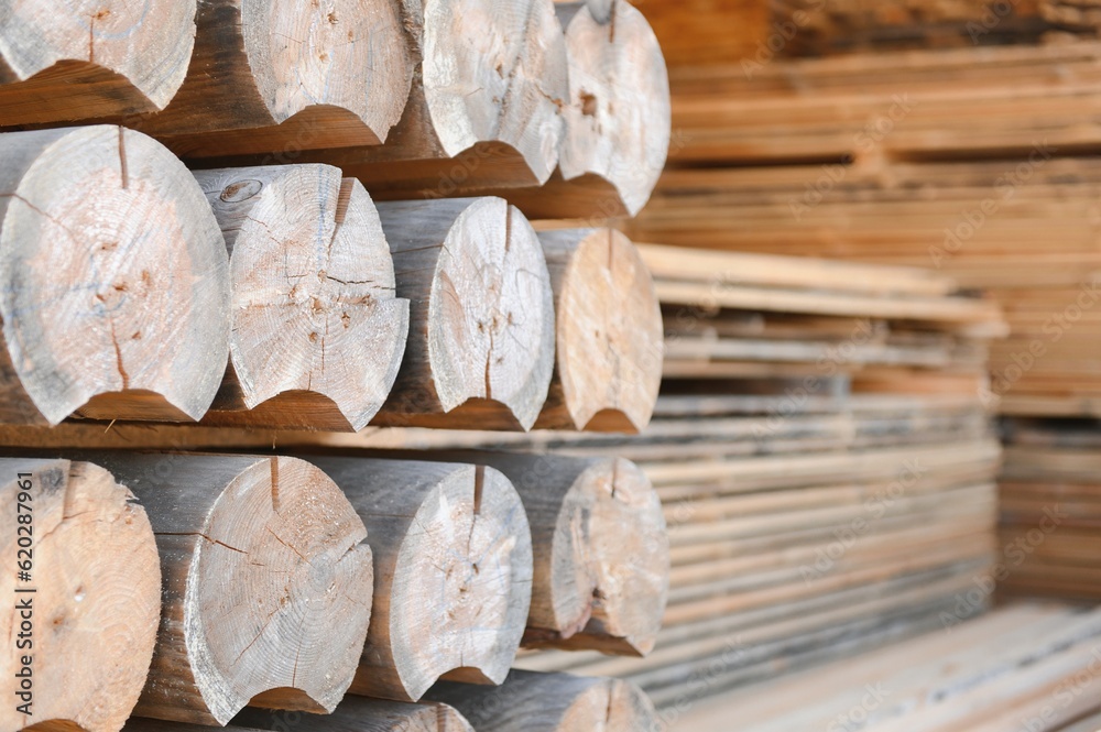 Round timber logs for building wooden house. Removing bark from logs ...